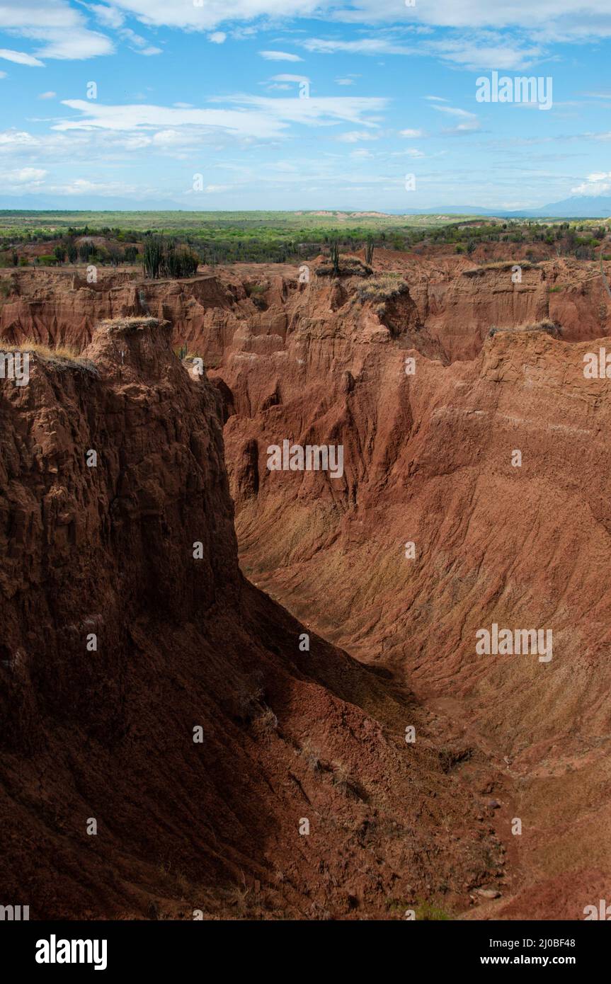 Steep cliff and valley of red orange sand stone rock formation in hot ...