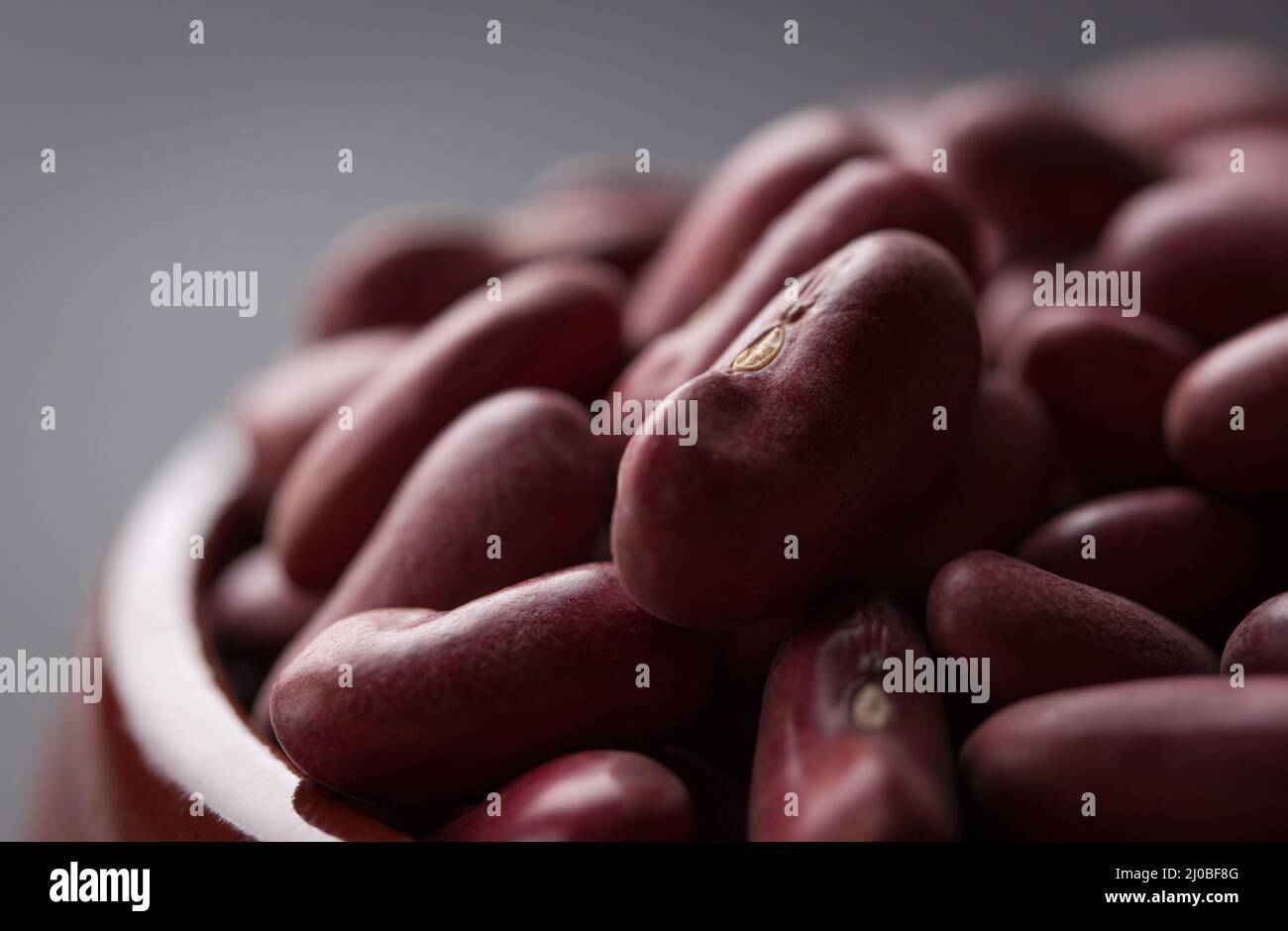 Red kidney bean in a red ceramic bowl on a black stone background Stock ...