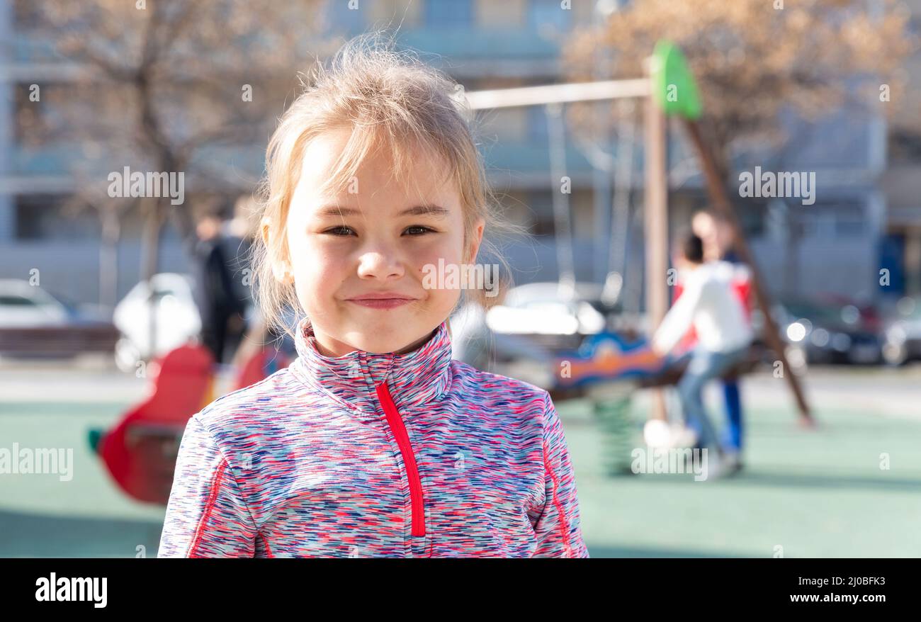 Portrait of positive little girl at the playground Stock Photo - Alamy
