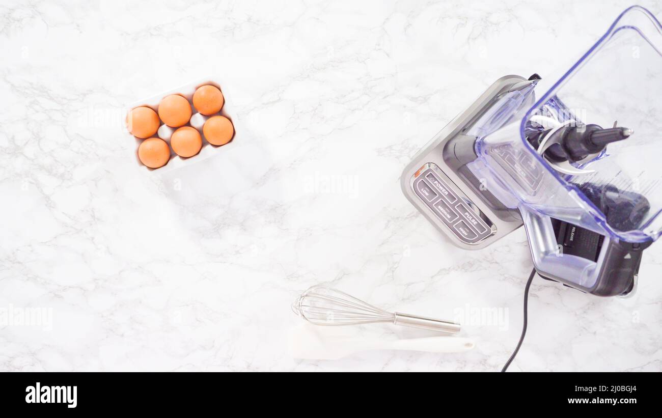 Flat lay. Mixing ingredient in an electric blender to make the crepes ...