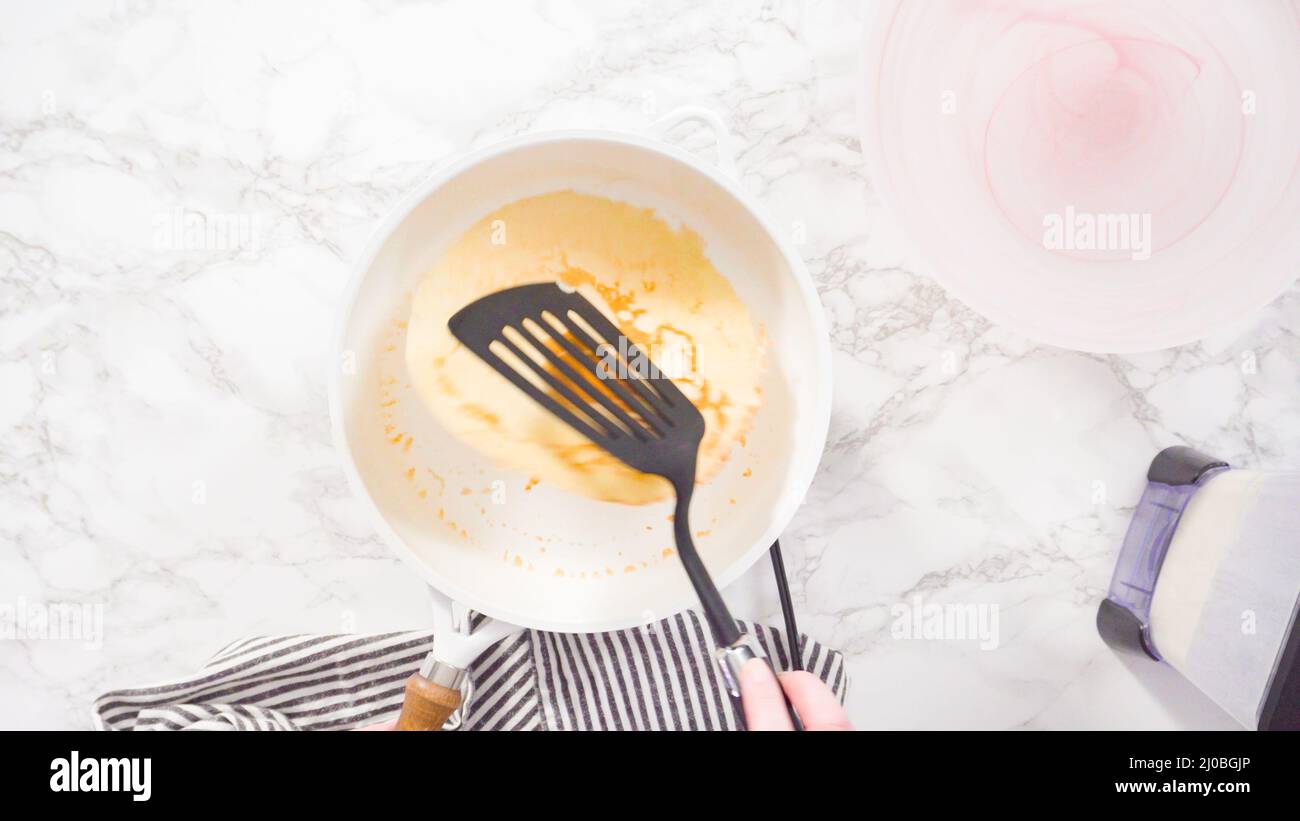Flat lay. Making crepes in a small frying pan over medium heat Stock ...