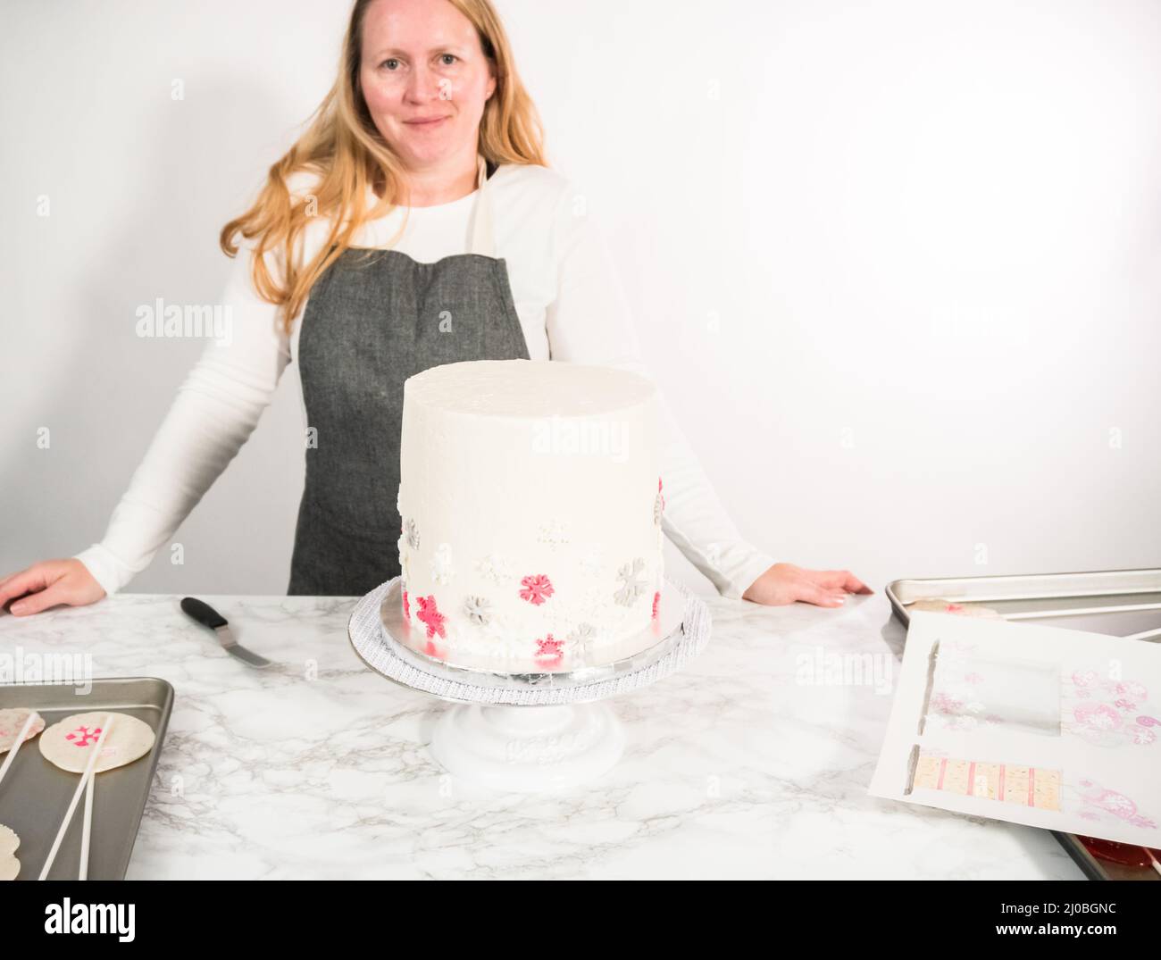 Baking tall round cake with large lollipops for a little girl's ...