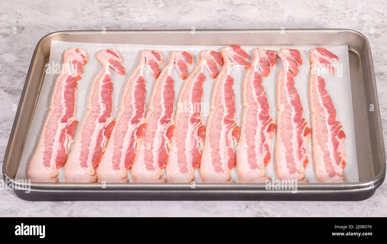 Step by step. Uncooked bacon strips on a baking sheet with white ...