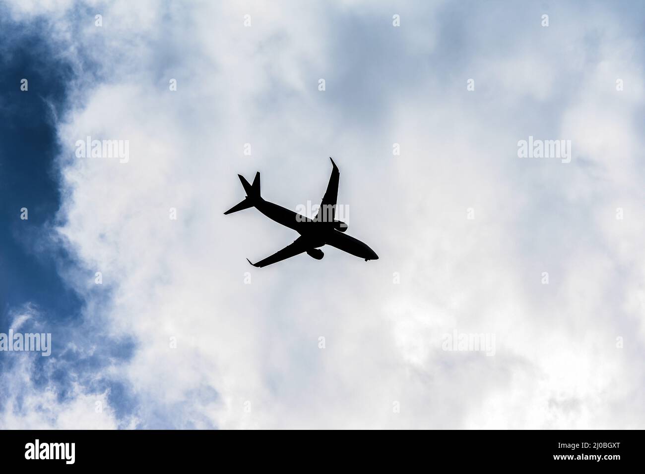 An airplane flying in the sky Stock Photo - Alamy