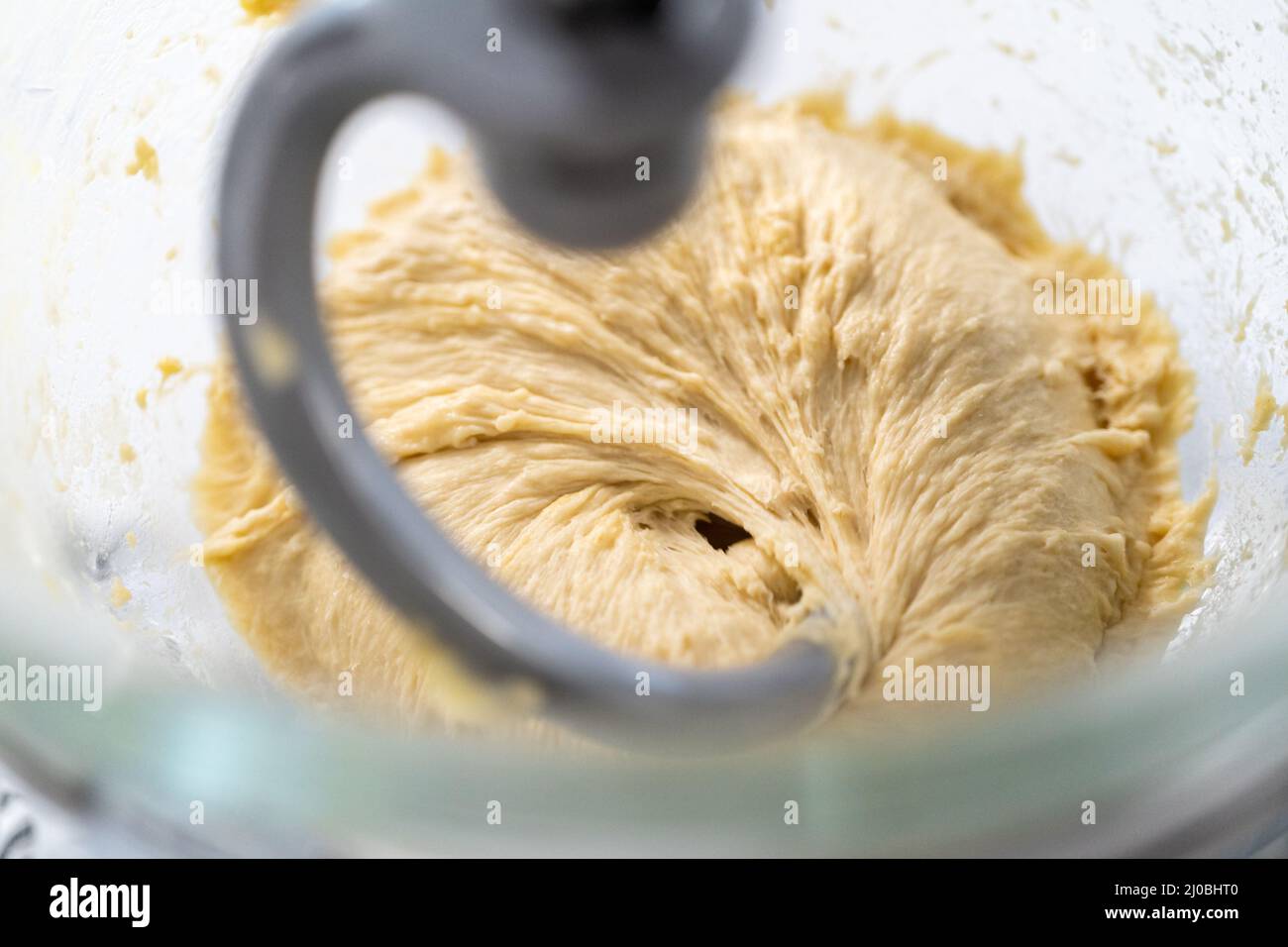 Mixing ingredients in kitchen mixer to bake homemade brioche buns Stock ...