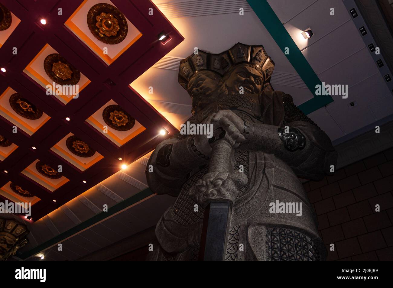 Low angle shot of 3 headed statue in Wen Wu temple Stock Photo - Alamy