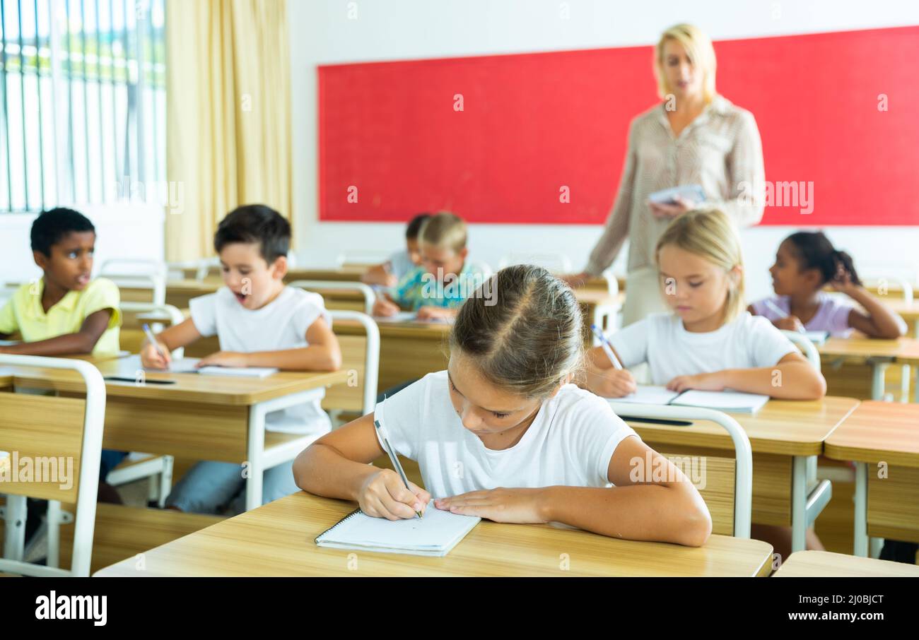 Group of focused kids working at class Stock Photo - Alamy