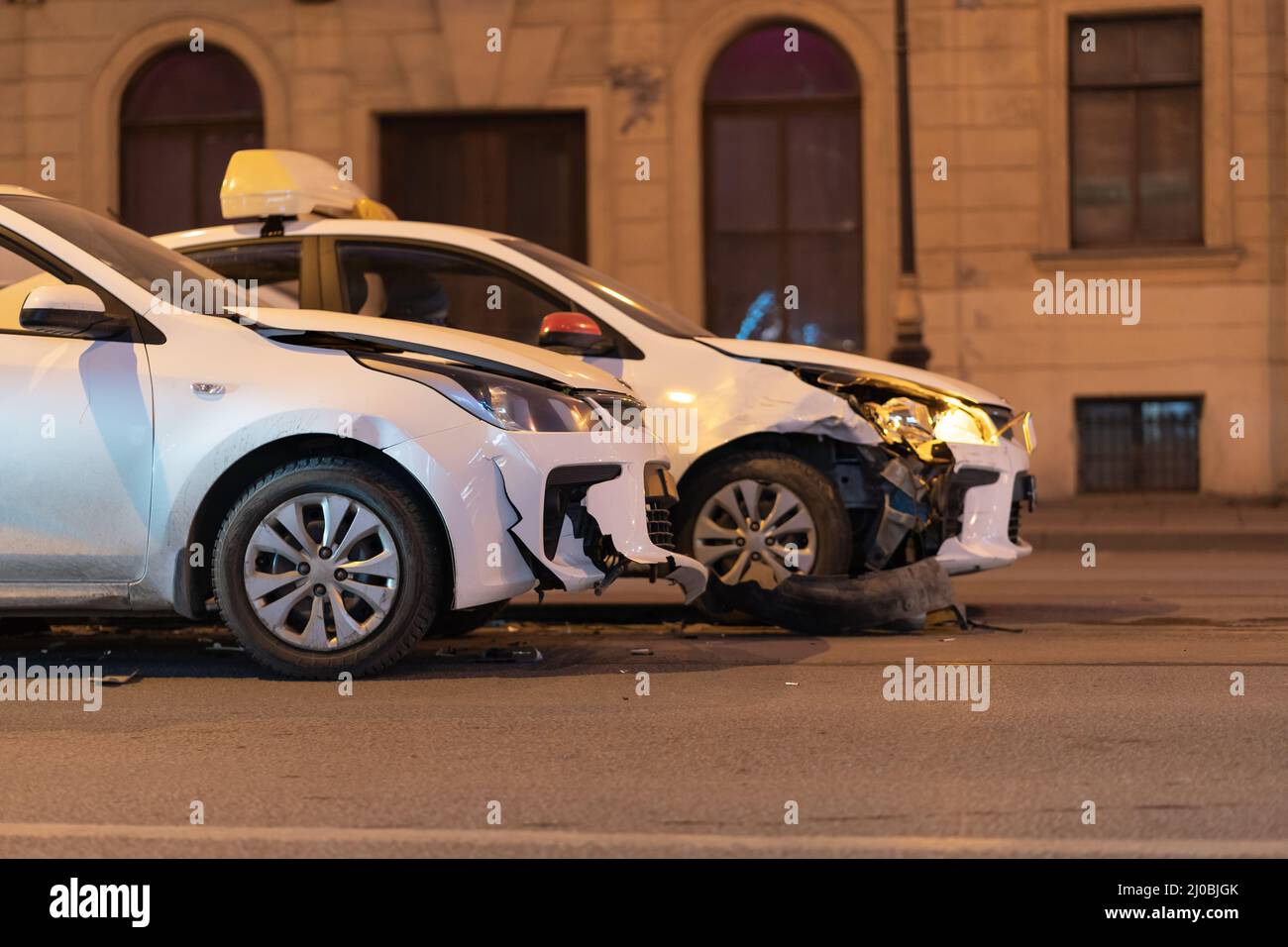 Damaged white cars on the road after accident with damaged bumpers ...