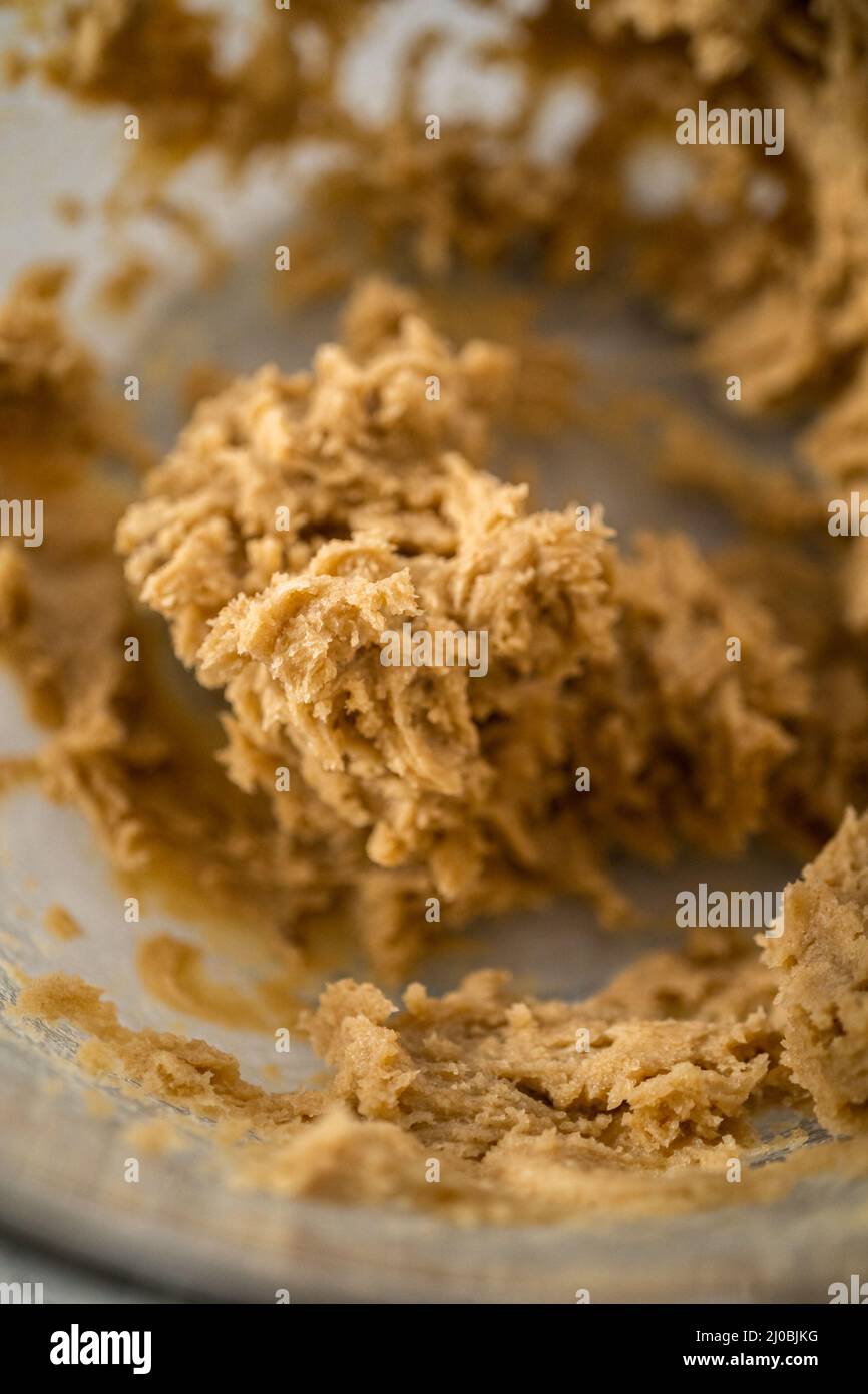 Mixing ingredients in a large glass mixing bowl with a kitchen mixer to ...