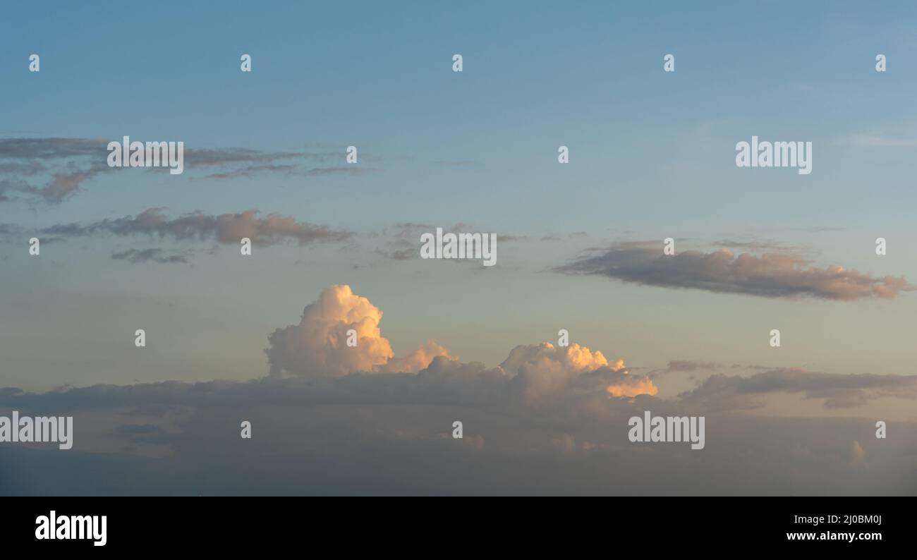Sunset blue sky background with clouds floating Stock Photo - Alamy
