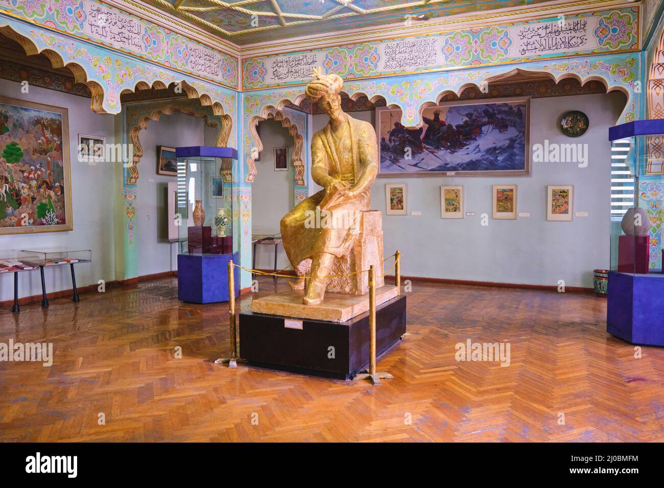 A large, gold statue, sculpture of a sitting Bobur. At the Alisher ...