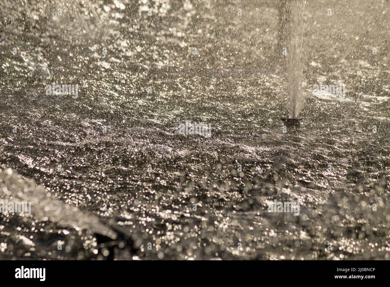 Water fountain with ripples and splashes closeup Stock Photo - Alamy