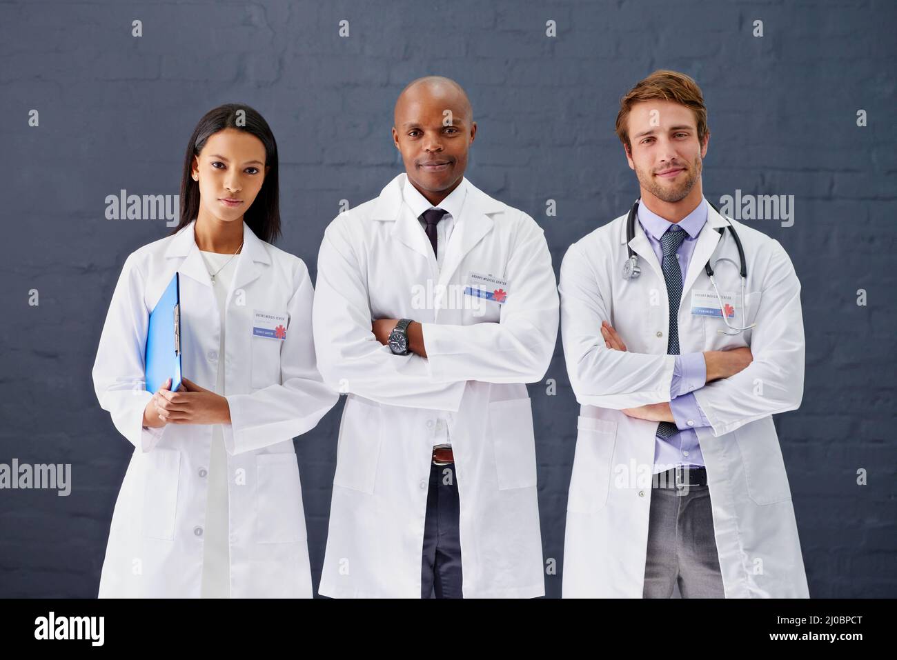 No doctor can do it on their own. Portrait of three doctors standing ...