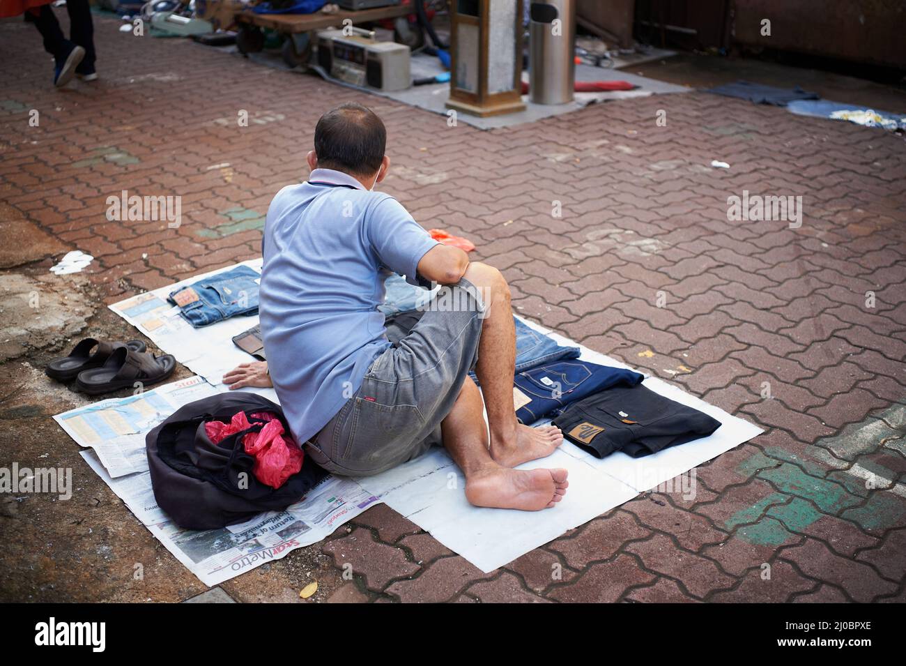 A lone man on roadside stall Stock Photo - Alamy