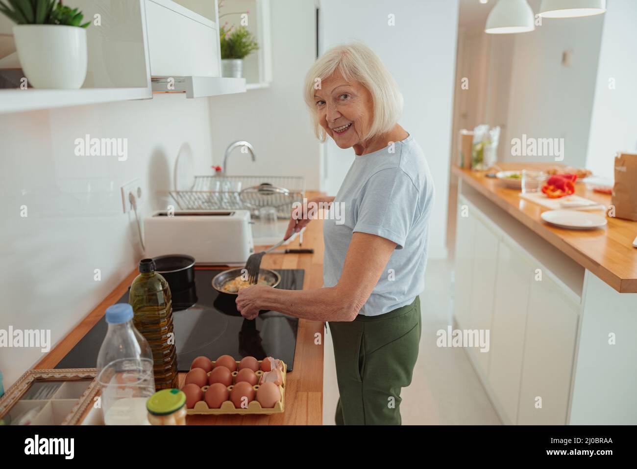 Lady cooking in kitchen hi-res stock photography and images - Alamy