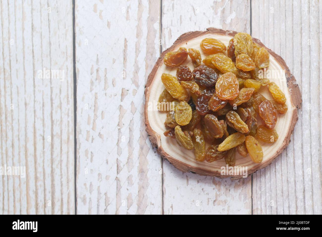 big size raisin on white wooden background Stock Photo - Alamy