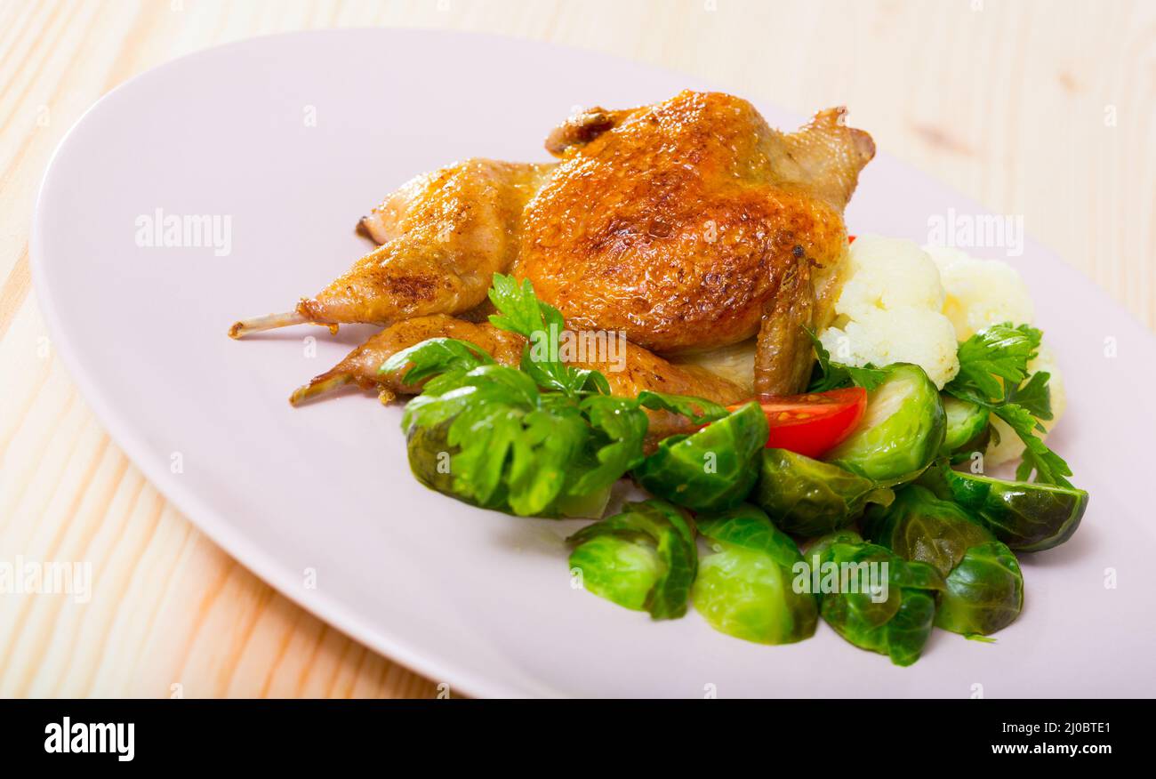 Grilled partridge with steamed vegetables Stock Photo - Alamy
