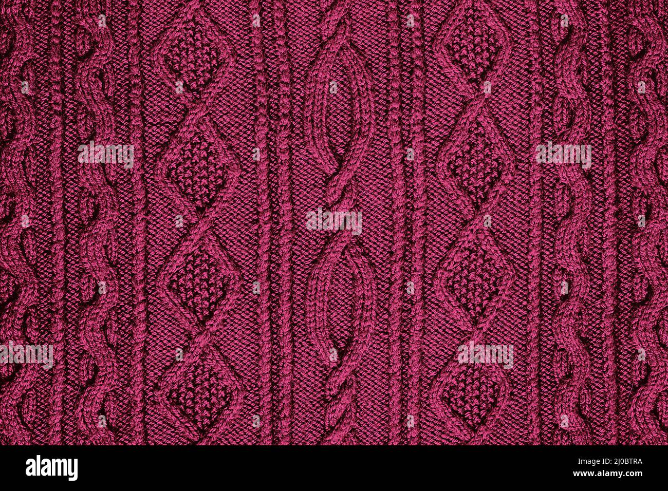 Background burgundy knitted fabric with a pattern closeup Stock Photo ...