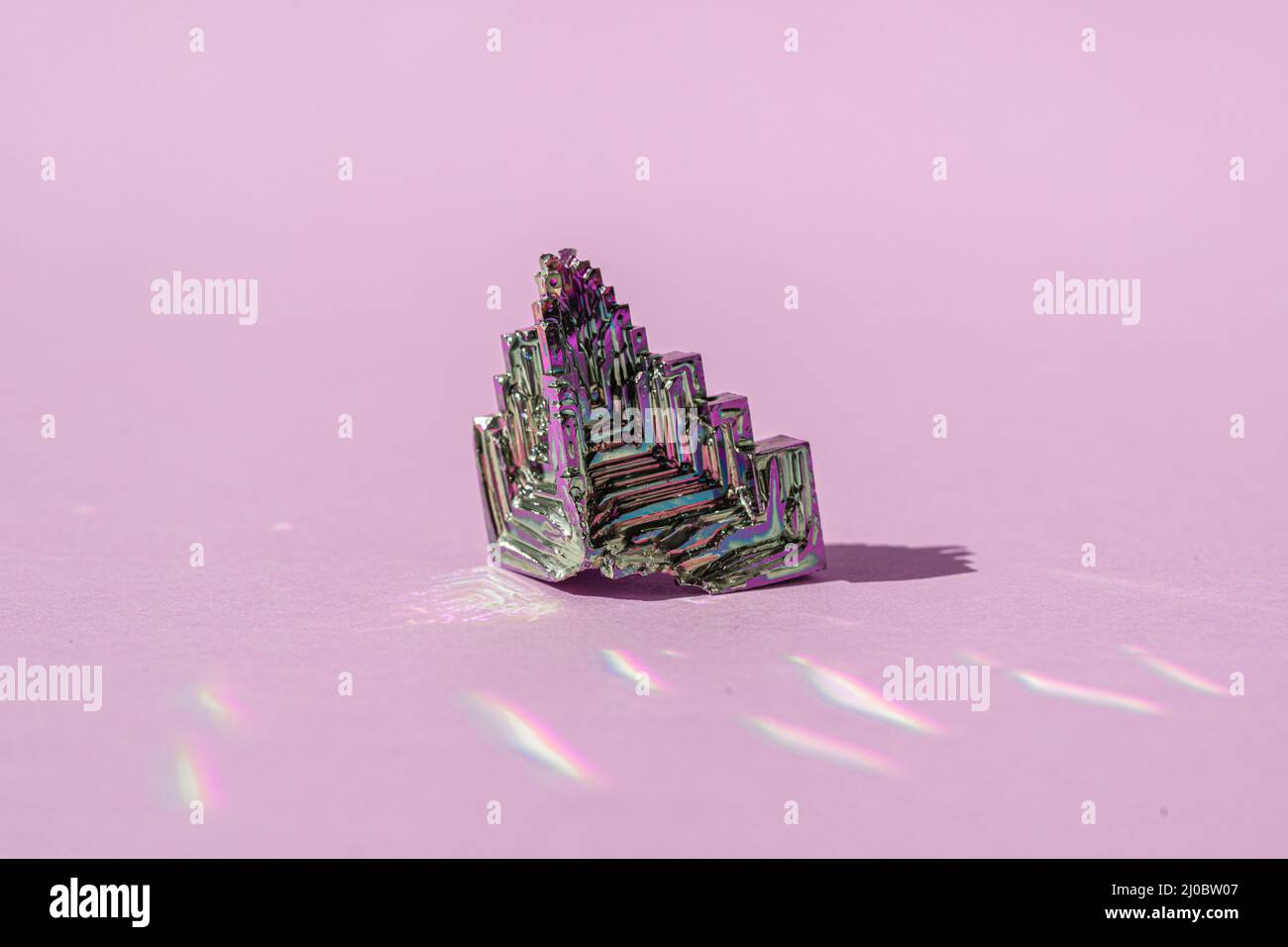 Synthetic bismuth Bismuthum crystal with iridescent oxide film on pink ...