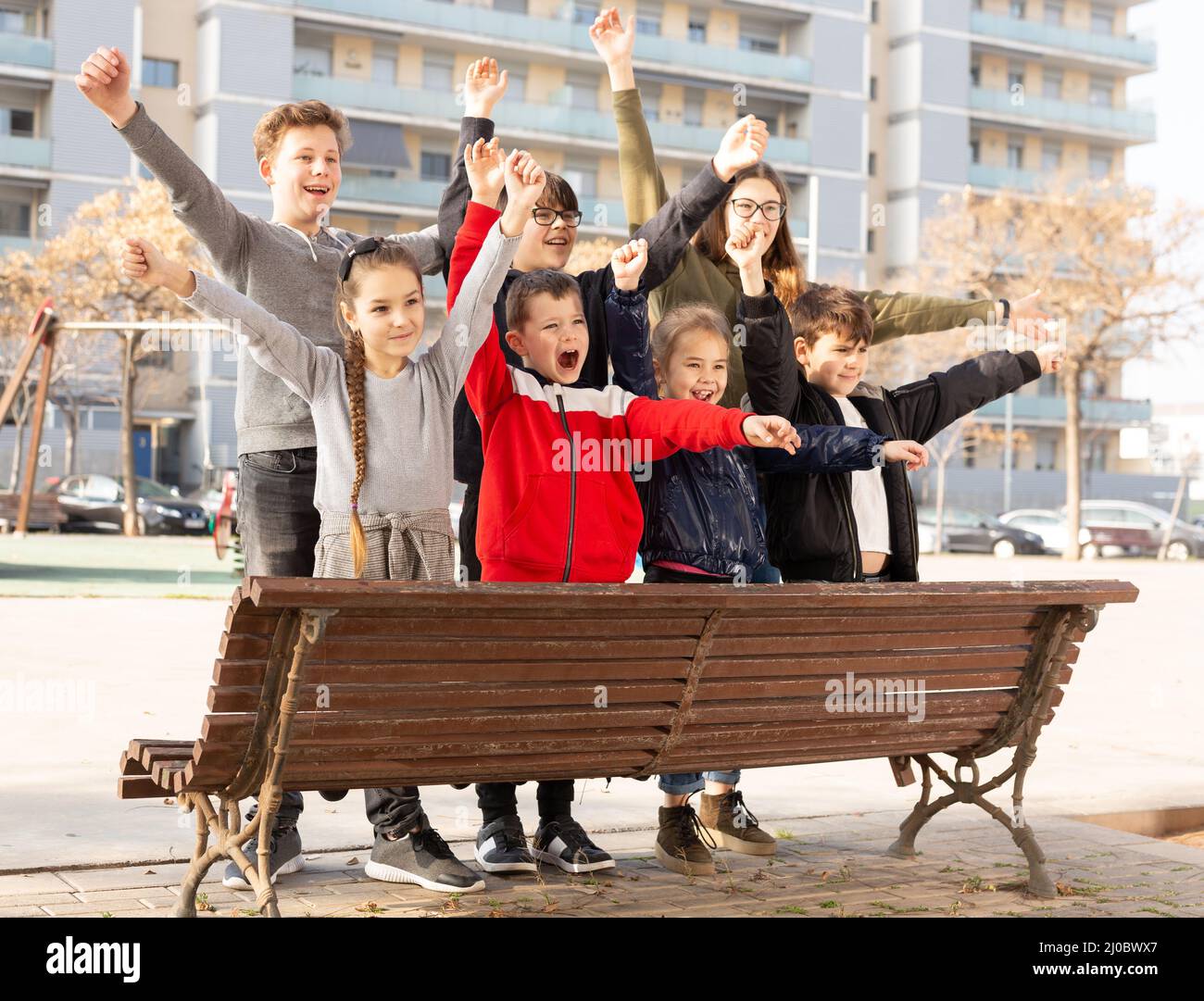 Portrait of happy kids standing together on playground in spring day ...