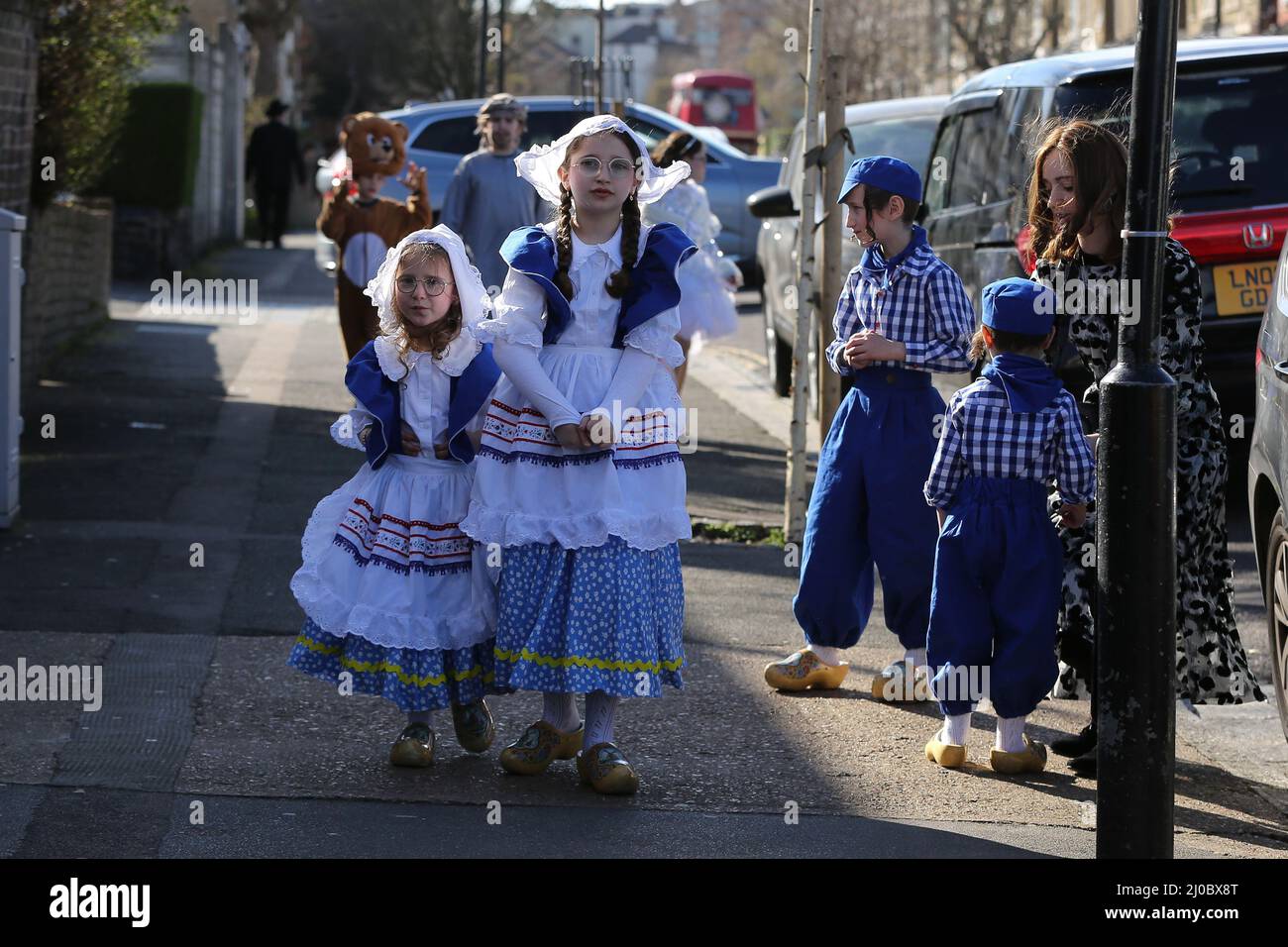 London, UK. 17th Mar, 2022. Orthodox Jewish girls in fancy dresses take ...