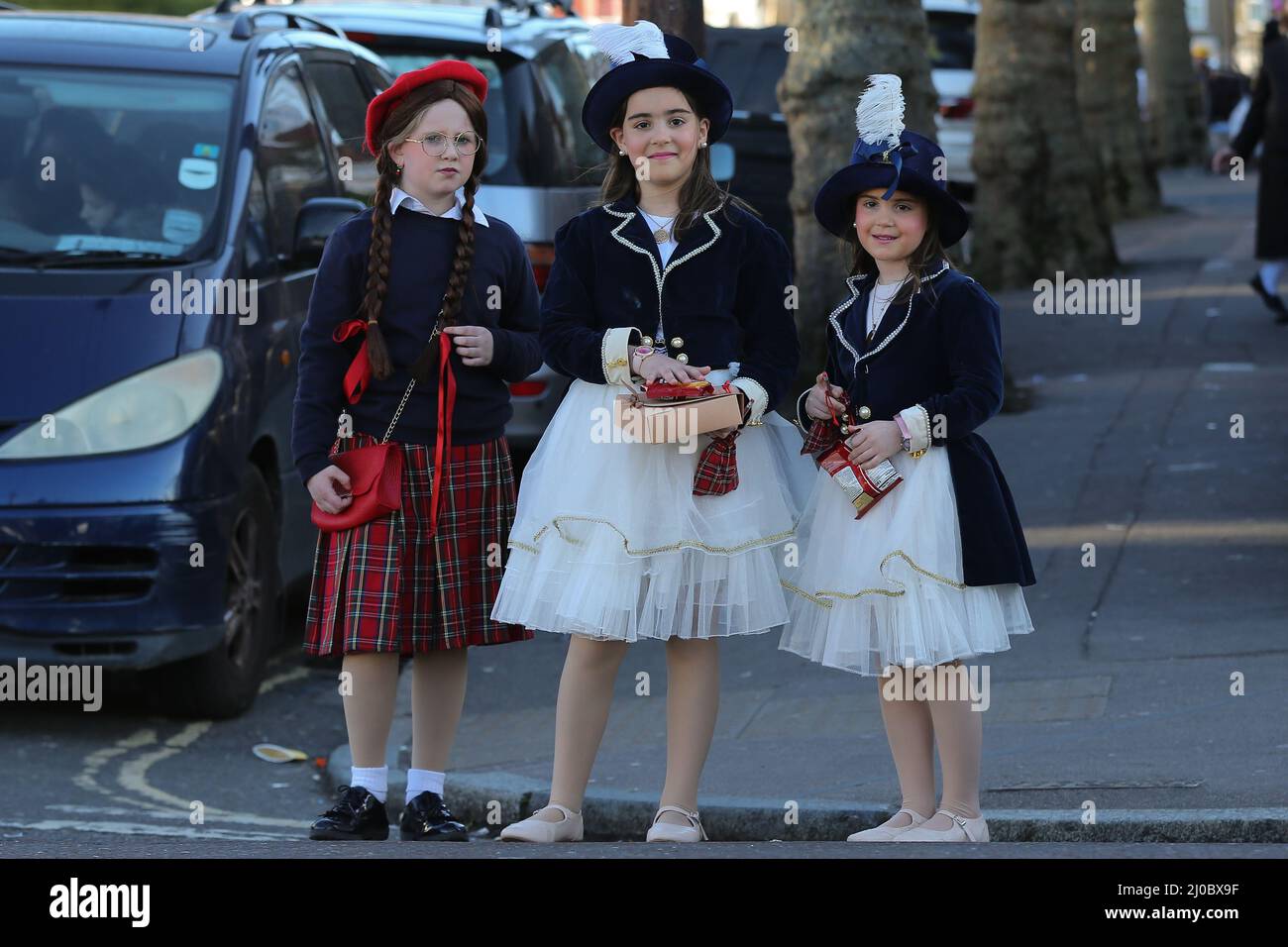 London, UK. 17th Mar, 2022. Orthodox Jewish girls in fancy dresses take ...