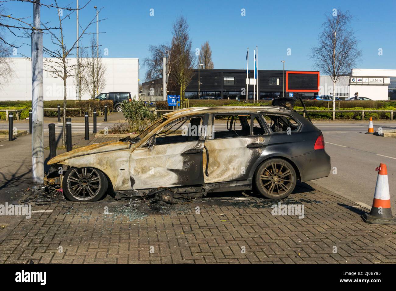 A burnt-out BMW car in a supermarket car park Stock Photo - Alamy