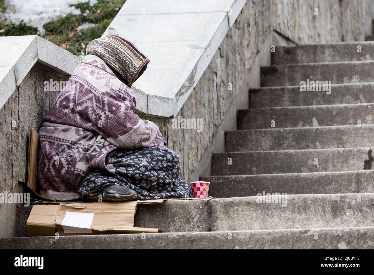 Homeless gypsy woman begging for money alone Stock Photo - Alamy