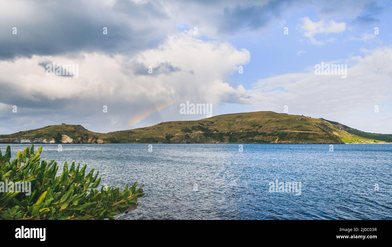 Lake of Aramoana with a rainbow visible from the mountains in the ...