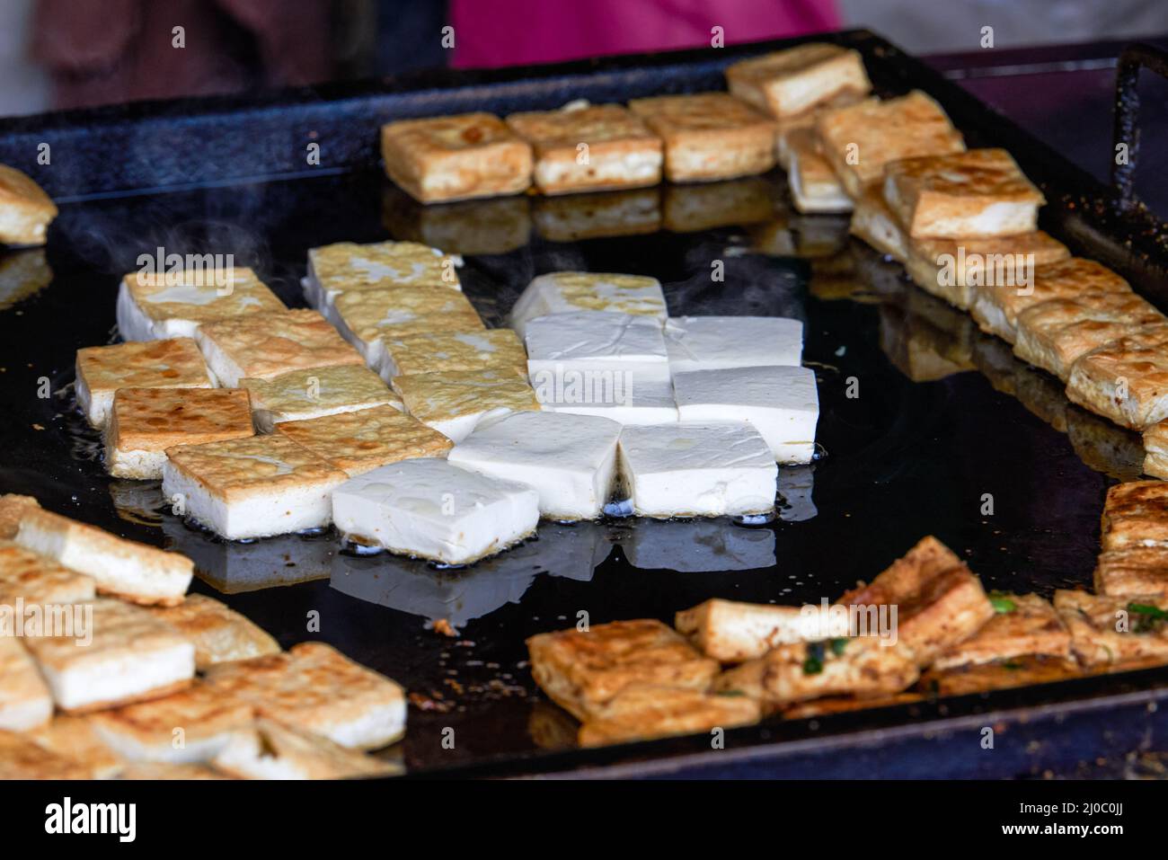 Golden tempting fried tofu on a food stand Stock Photo - Alamy
