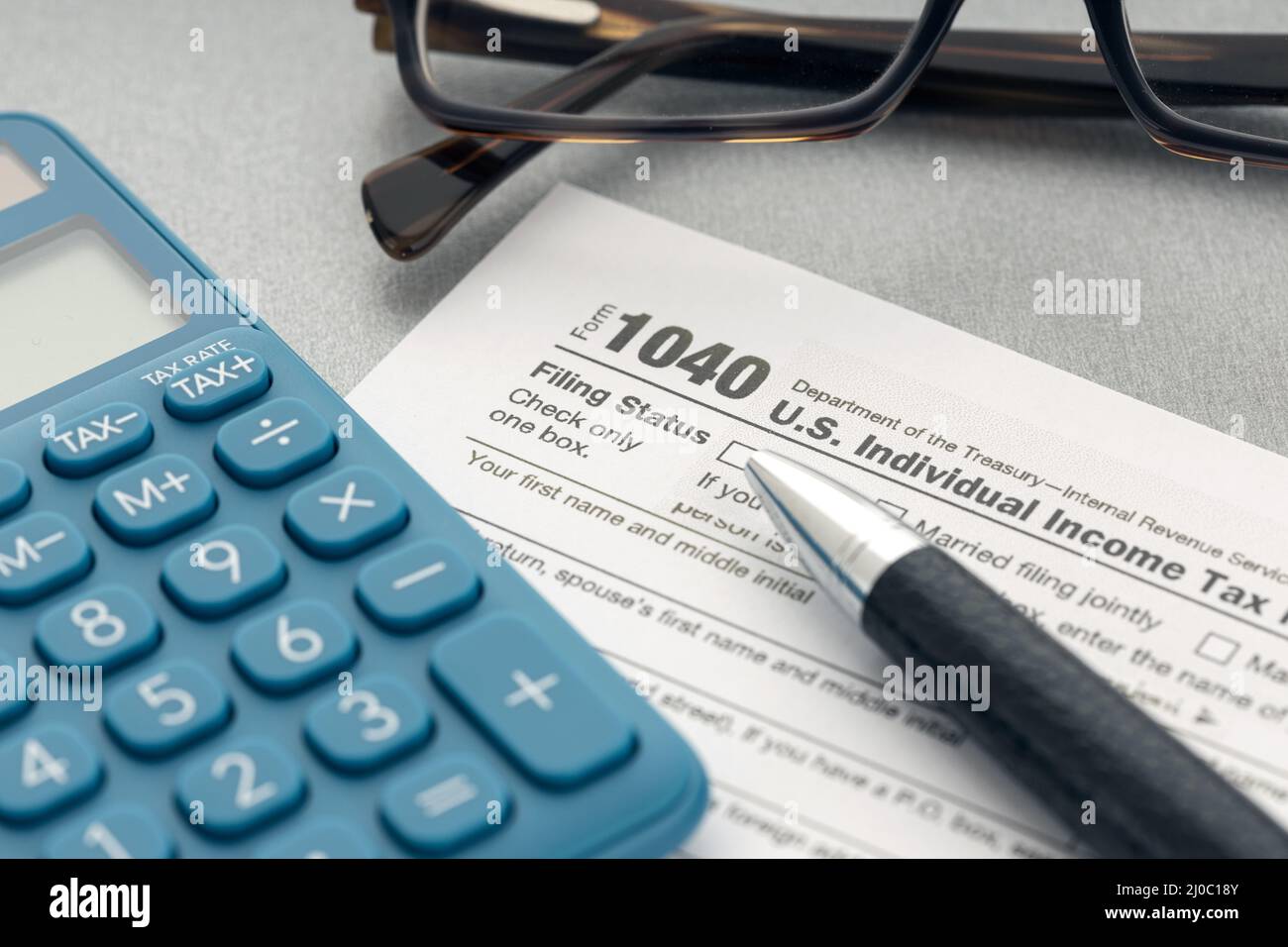 Calculator calculating tax form hi-res stock photography and images - Alamy