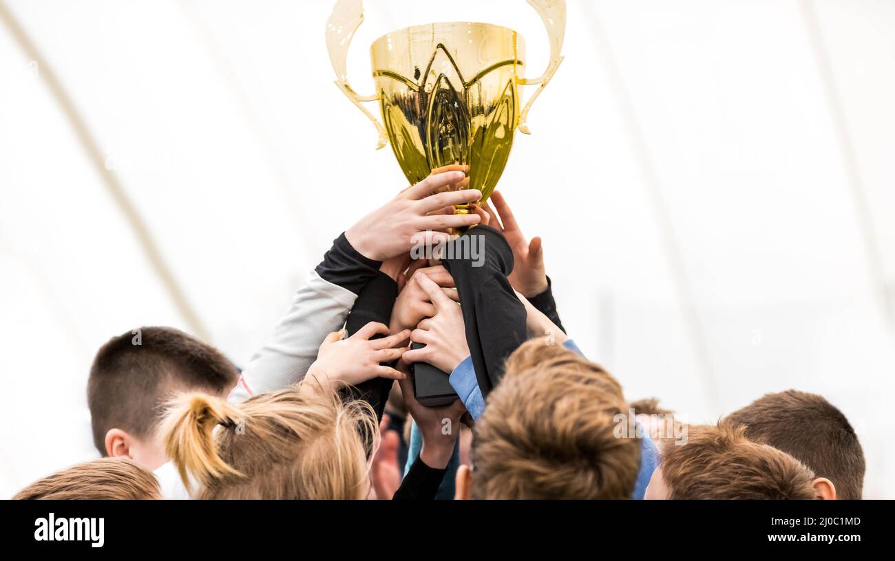 Happy kids winning sports tournament. Schoolboys standing in a circle ...