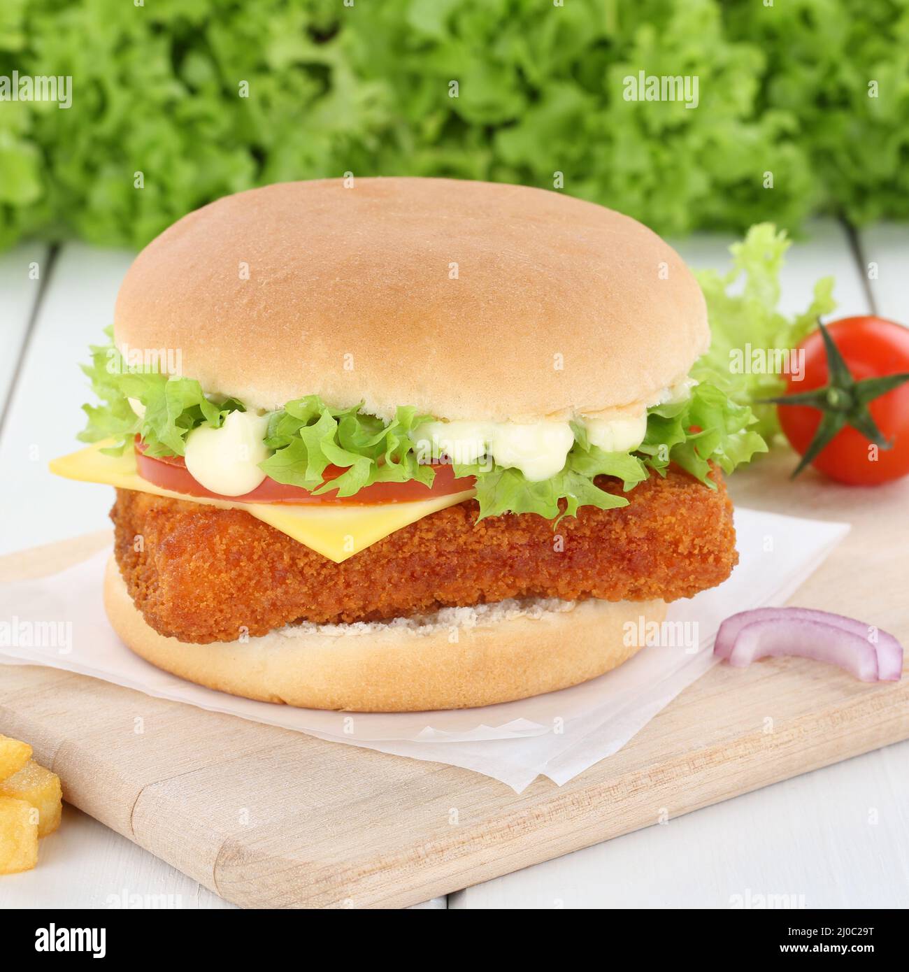 Fish burger baked fish hamburger fresh onion cheese tomato salad Stock ...