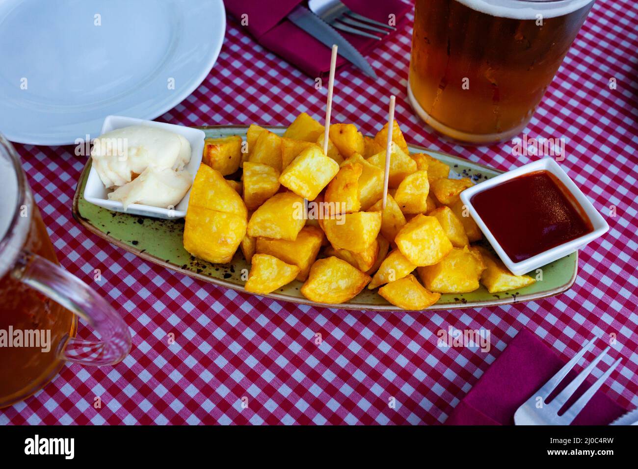 Spanish dish Patatas bravas with hot sauce Stock Photo - Alamy