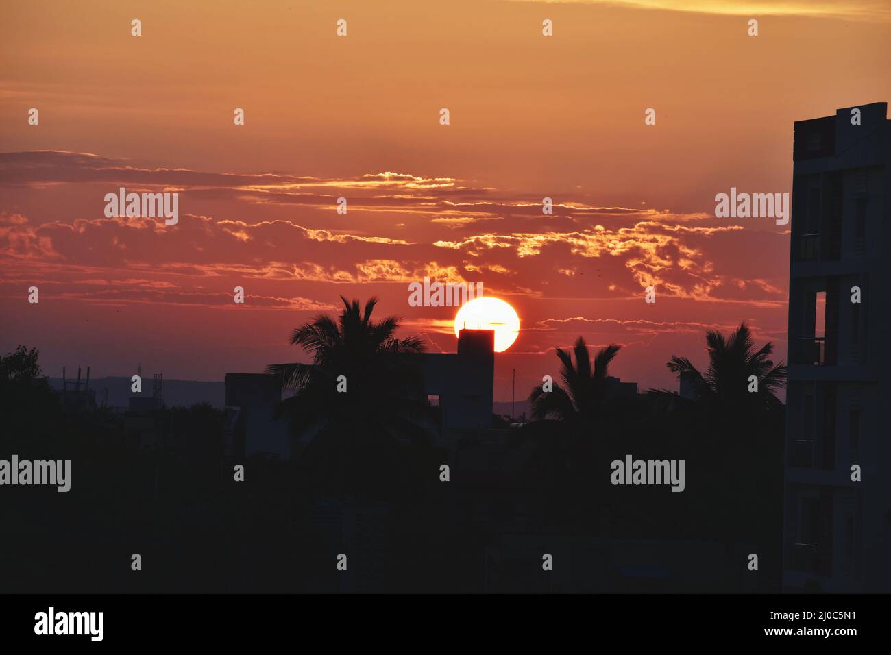 Beautiful orange sunset sky with the sin still visible at the sunset ...