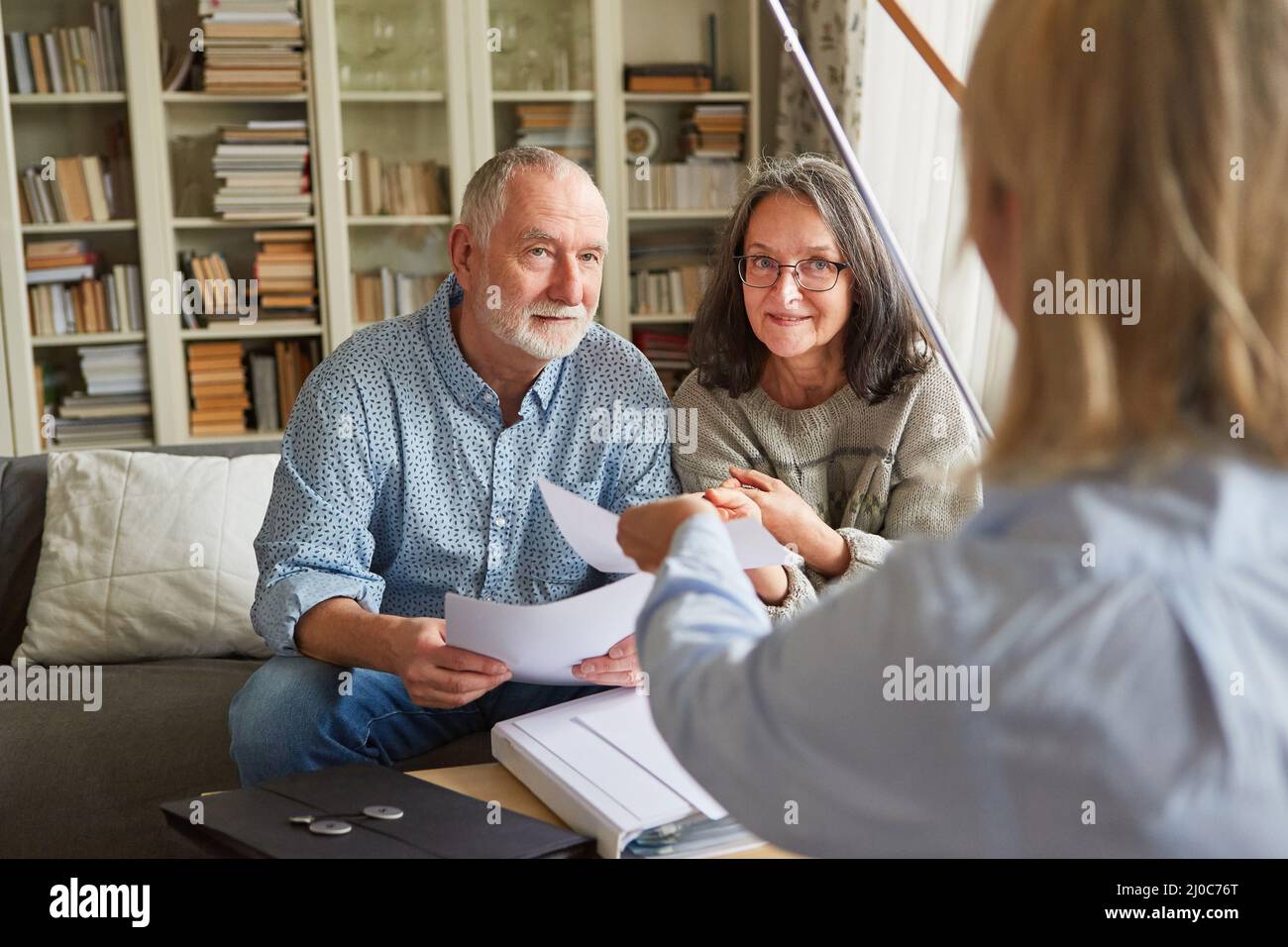 Couple of seniors getting advice on retirement and care from a senior ...