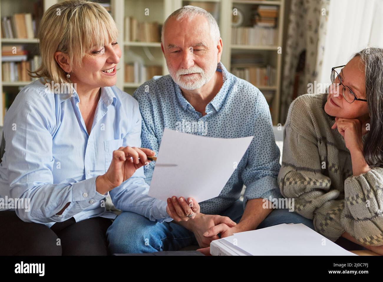 Tax advisor or senior advisor explains a contract or an application to ...