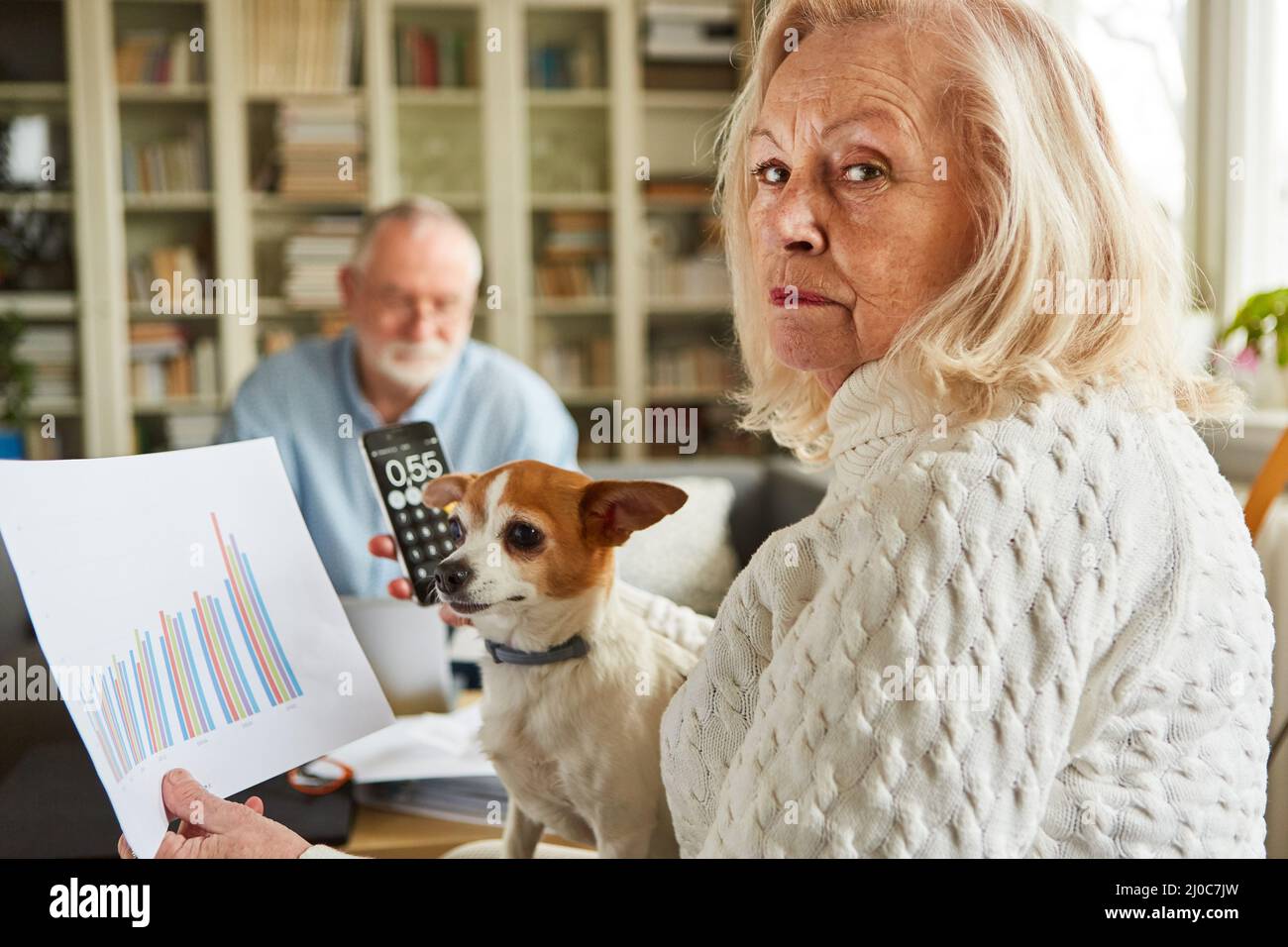 Senior woman with calculator and chart worried about private pension ...
