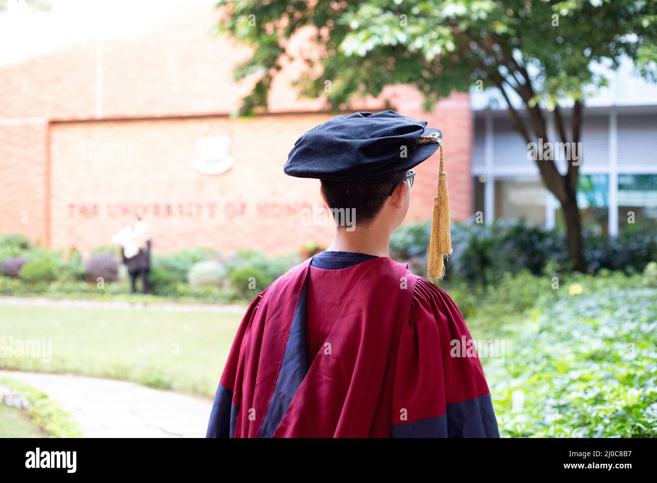 two happy proud PhD graduated male students in Academic dress gown ...