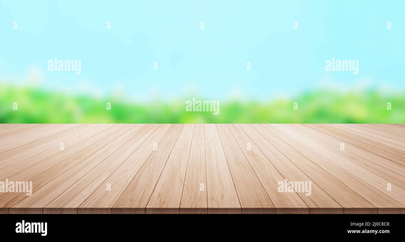 Empty wood table top on green leaf and blue sky background for display ...