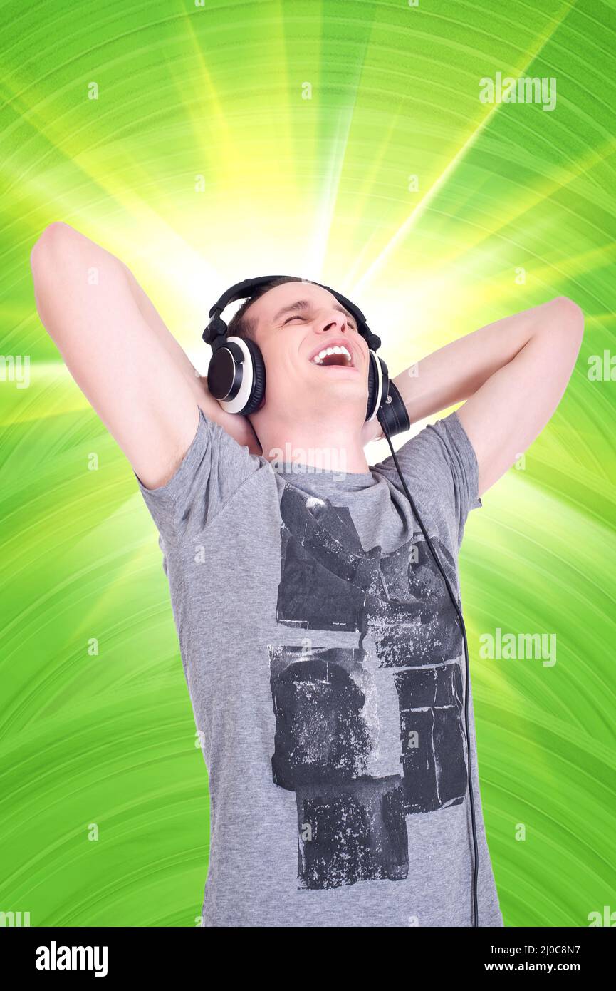 Portrait of a happy young man enjoying music with headphones Stock ...