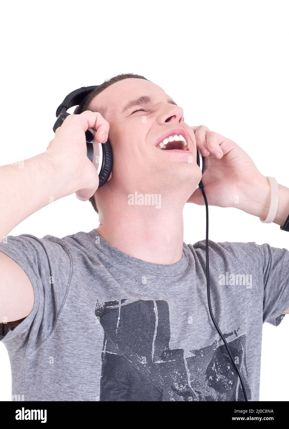 Close-up of a happy young man enjoying music with headphones Stock ...