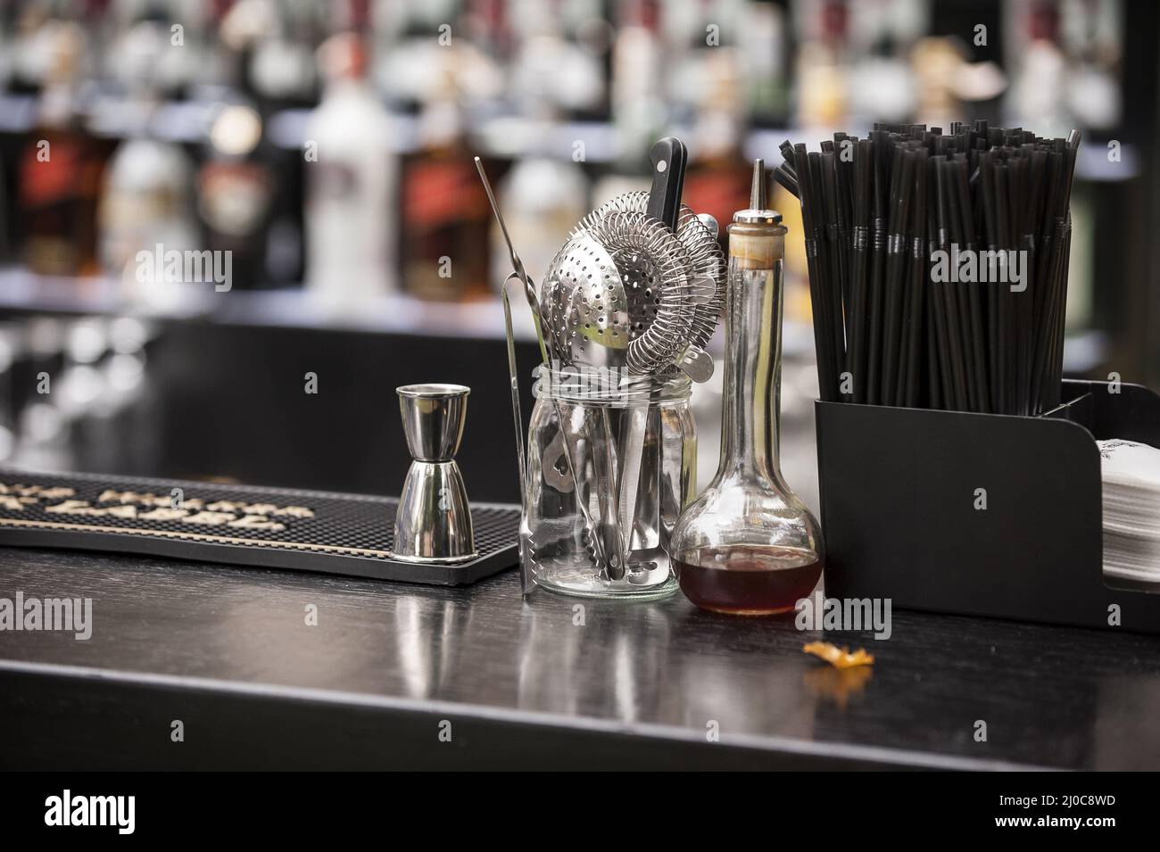 Classic bar counter with bottles in blurred background Stock Photo - Alamy
