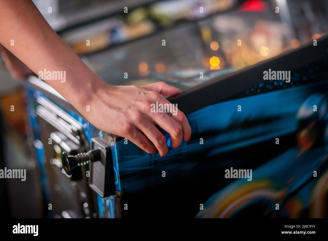 Hand of female pressing button and playing pinball machine Stock Photo ...