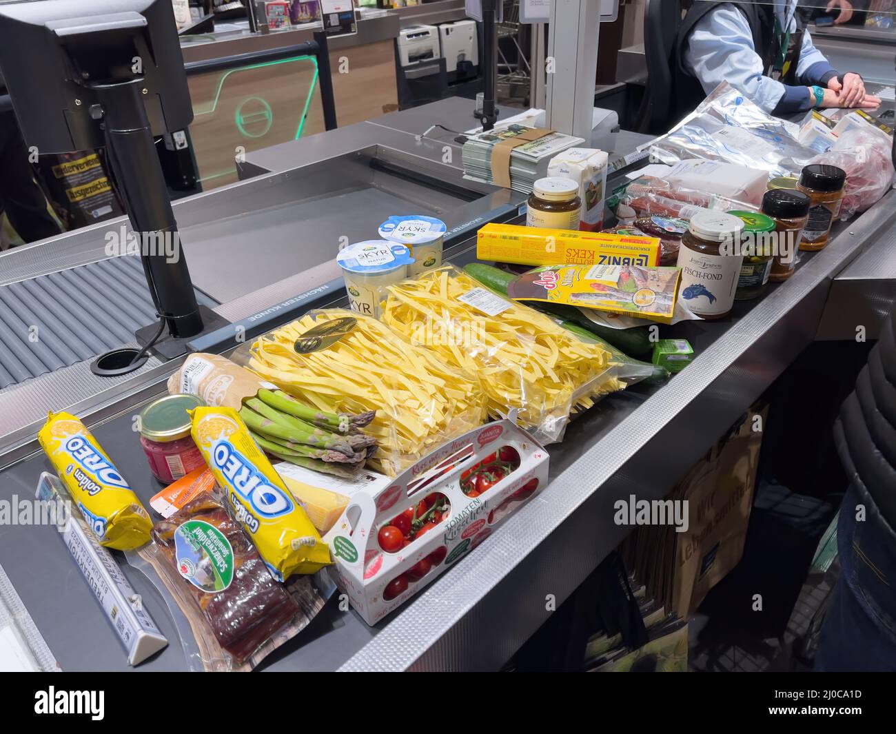 Karlsruhe, Germany - March 12, 2022: Cashier in background with ...