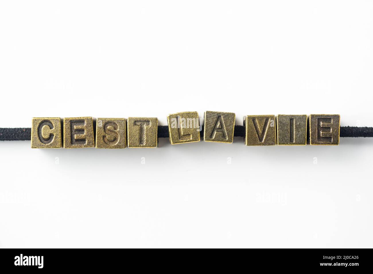 Creative design concept - top view of metal cube word c'est la vie link ...