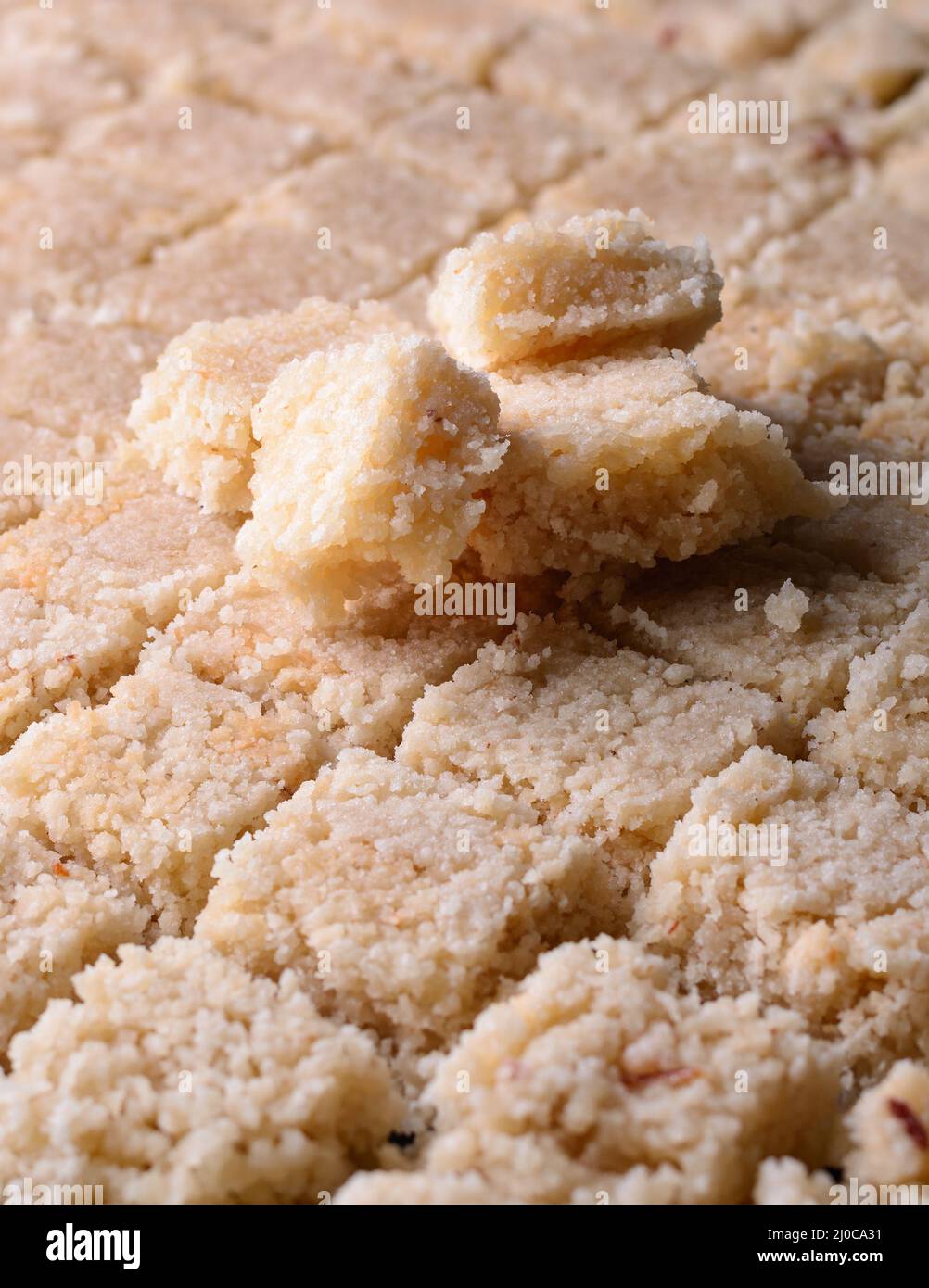 coconut toffees, sugary snack in shallow depth of field, closeup view ...