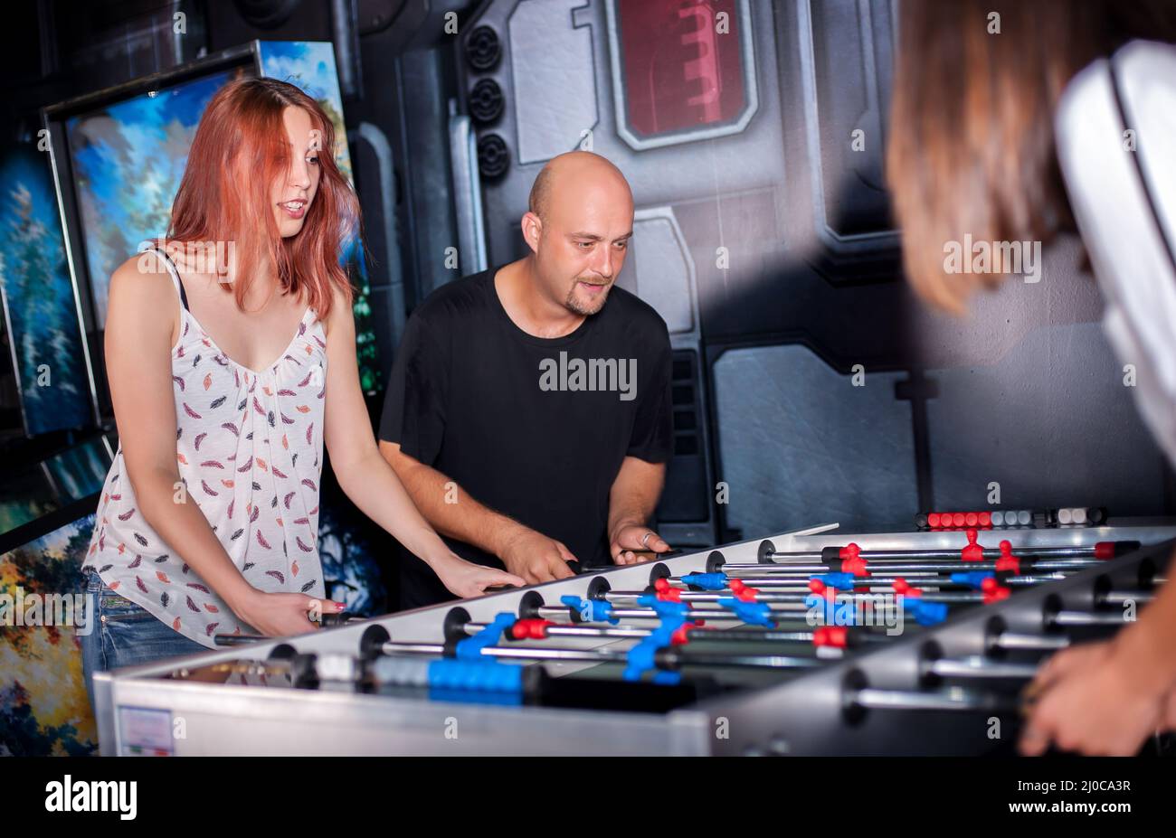 Group of friends playing soccer table foosball Stock Photo - Alamy
