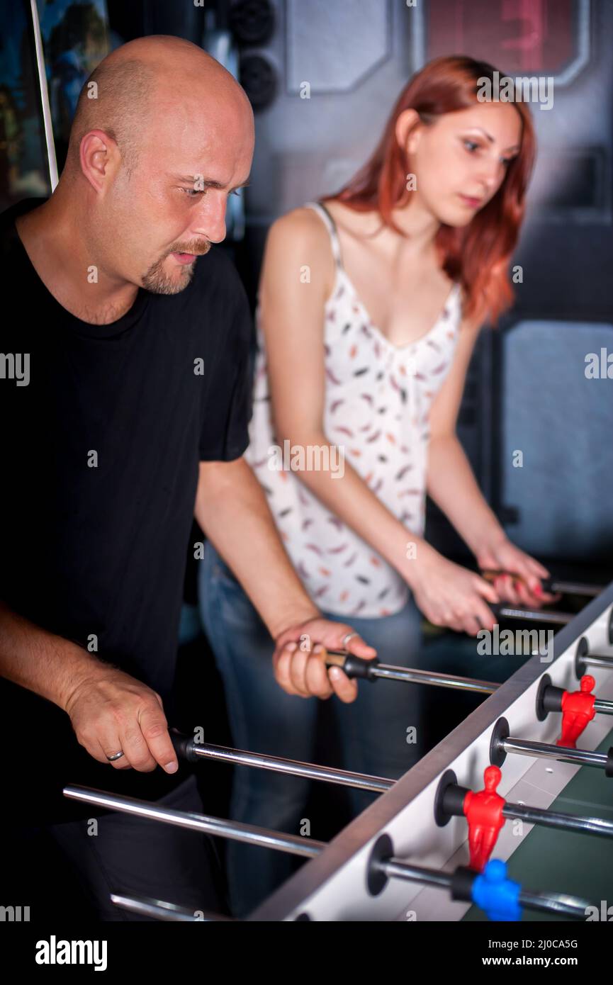 Group of friends playing soccer table foosball Stock Photo - Alamy