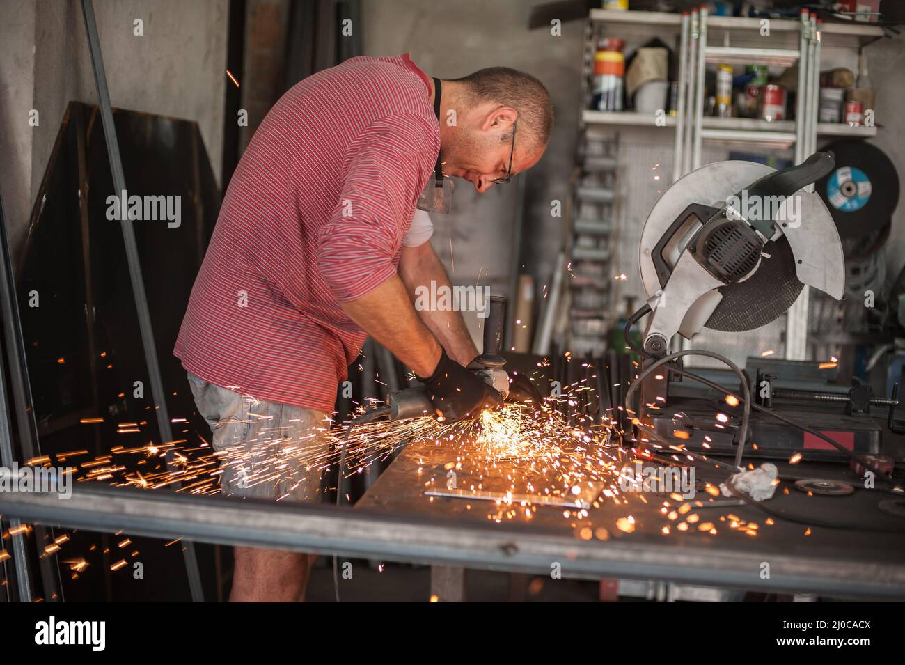 Electric wheel grinding on steel structure in factory. Sparks from the ...